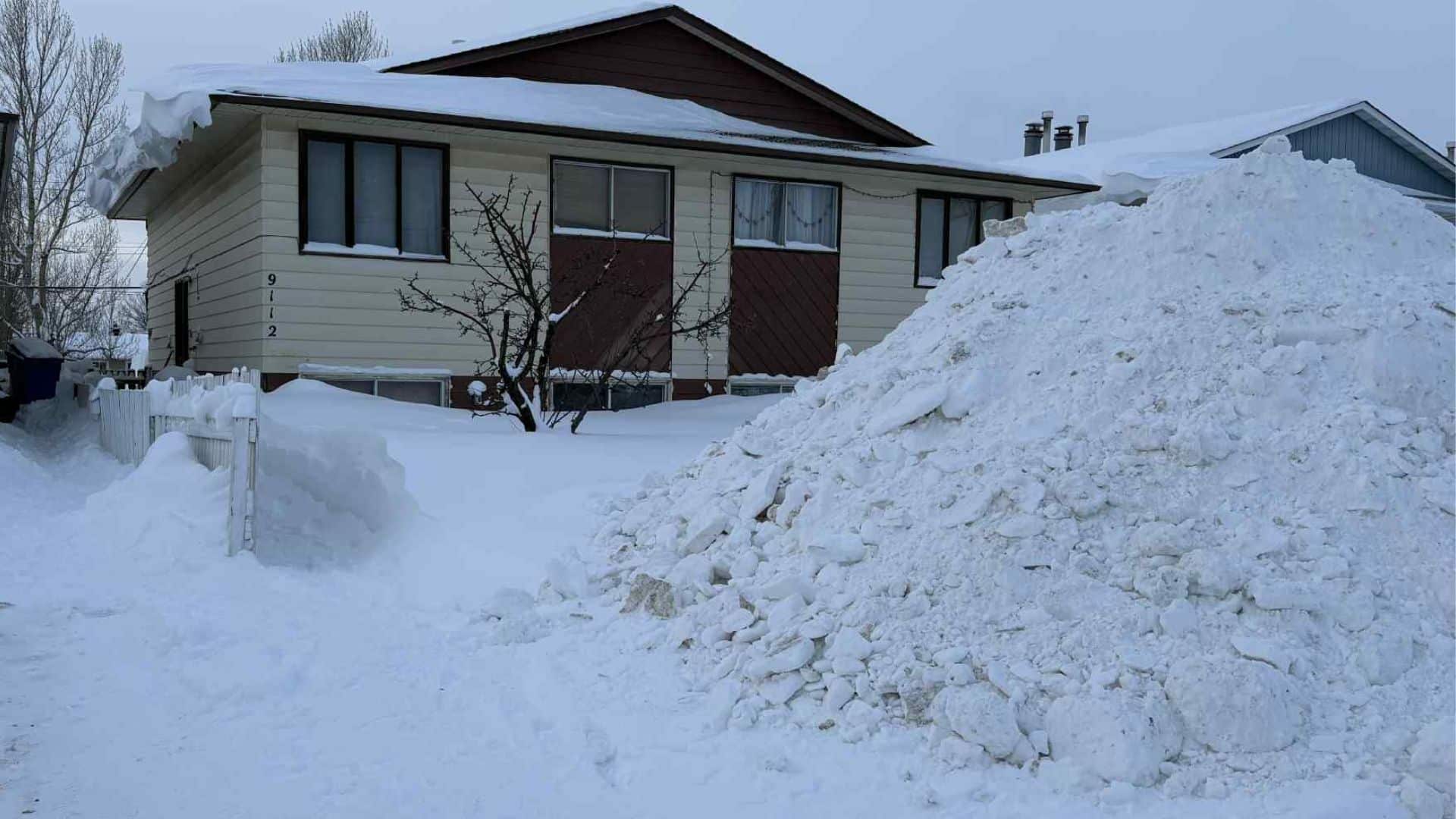 Ten-foot 'plowed' snow pile blocks driveway in Fort St. John
